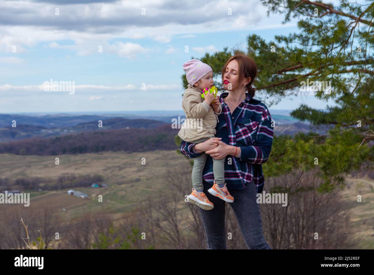 Portrait of a little girl and her mother. Mom and daughter are cute ...