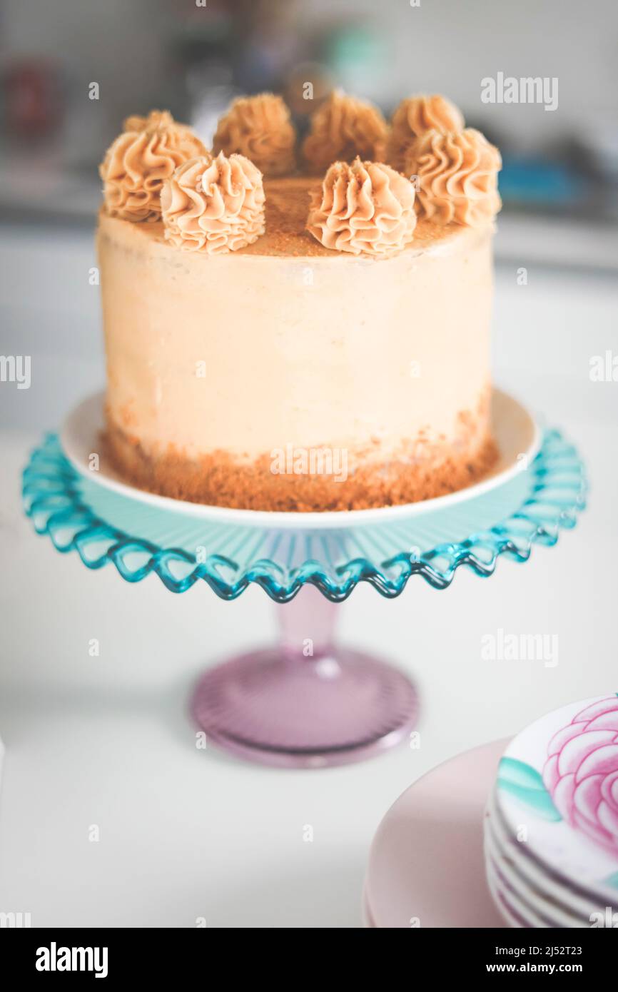 Sponge layer cake with buttercream icing on a cakestand Stock Photo - Alamy