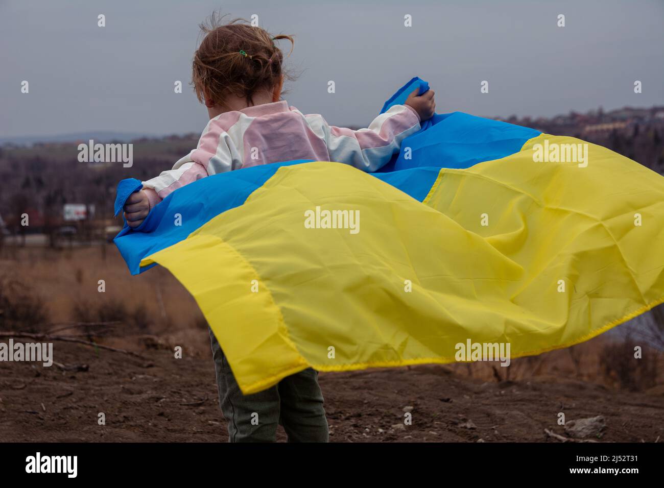 Beautiful baby girl with a flag of Ukraine against the backdrop of a ...