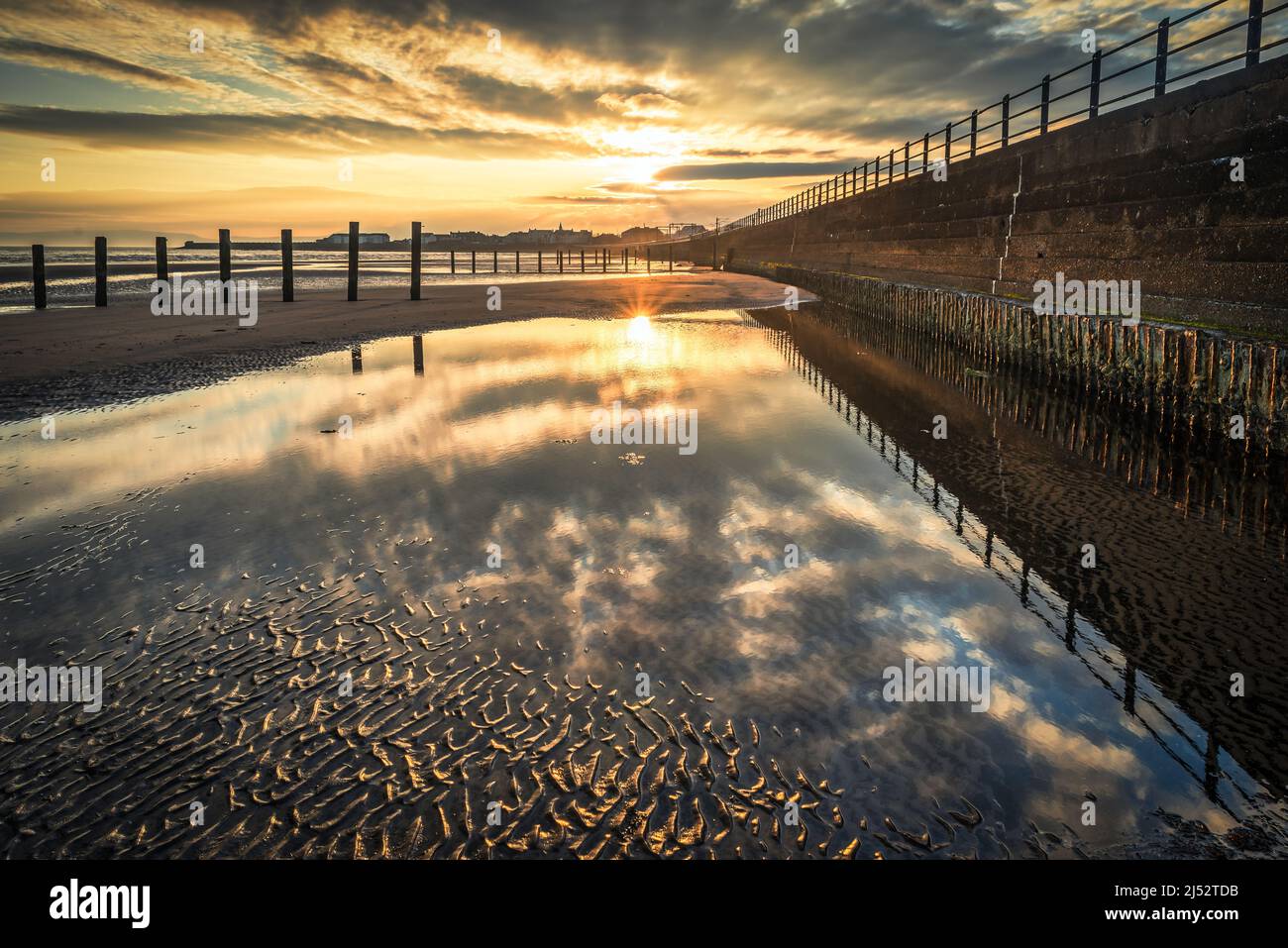 Clouds reflected in sea at Sunset, Saltcoates beach, North Ayrshire ...
