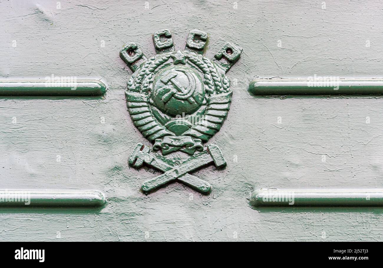 Coat of arms of former state the USSR on the retro train. Emblem of the ...