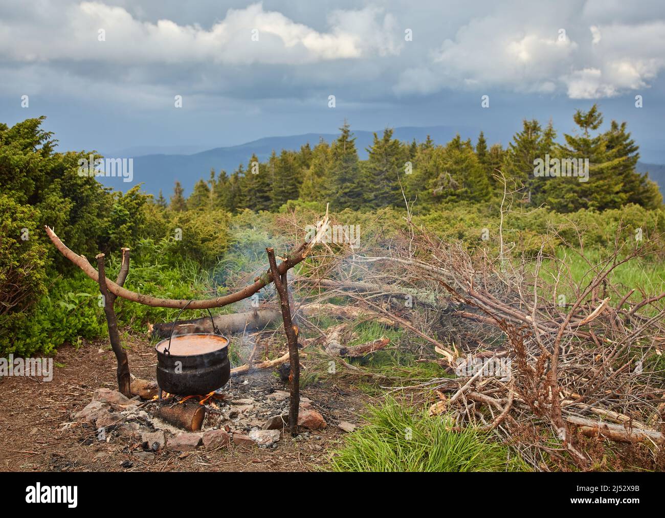 Cooking breakfast on fire in mountains. Camping season Stock Photo - Alamy