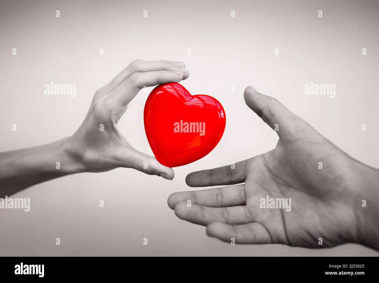 Hand giving heart to another isolated. Giving donation concept Stock ...