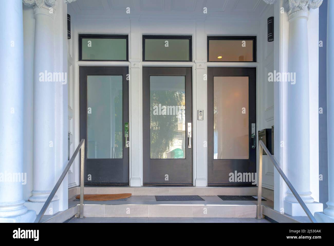 Three black front doors with glass panels and transom windows at San ...