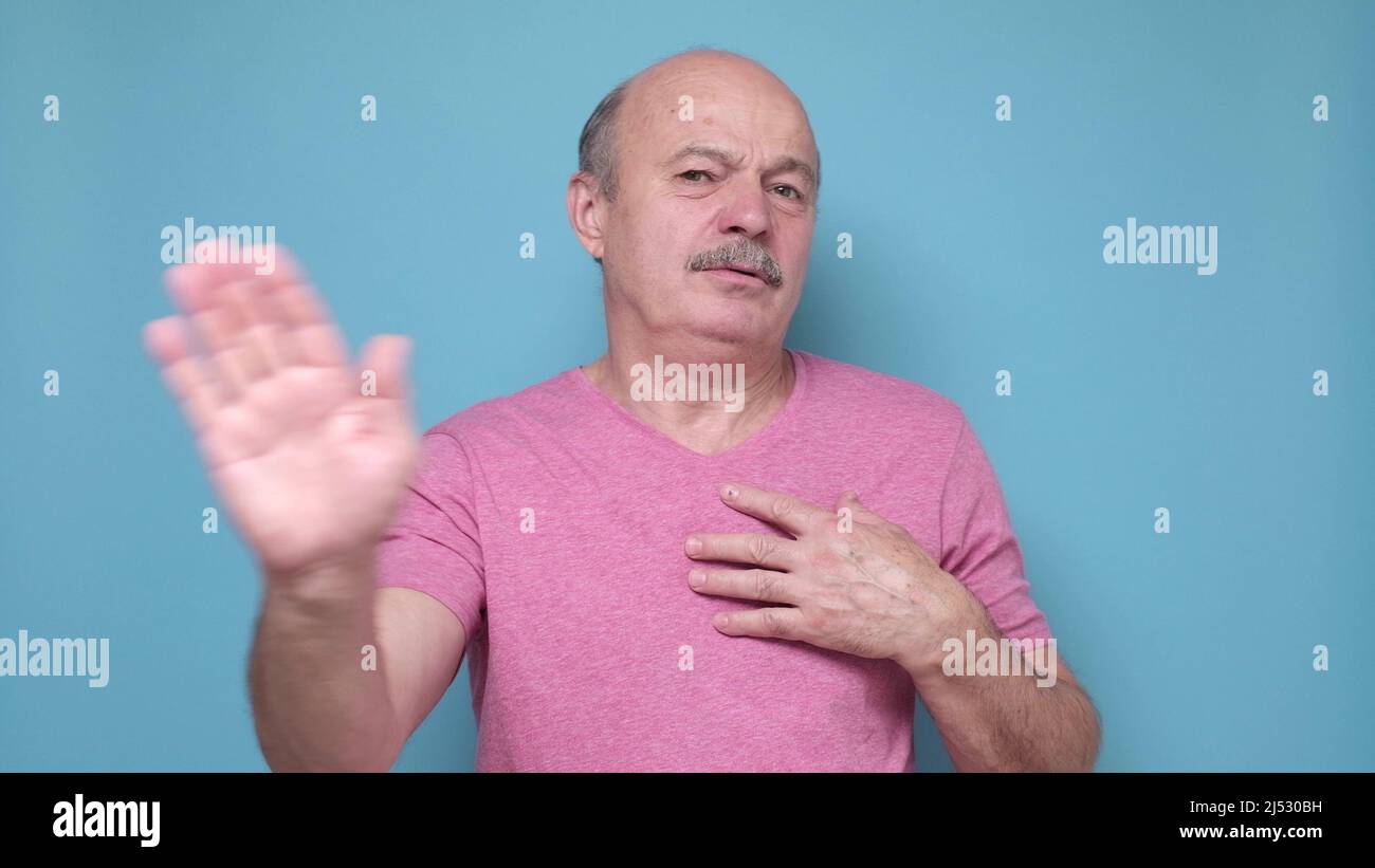 Senior man shows stop gesture. Father refusing from something. Studio ...