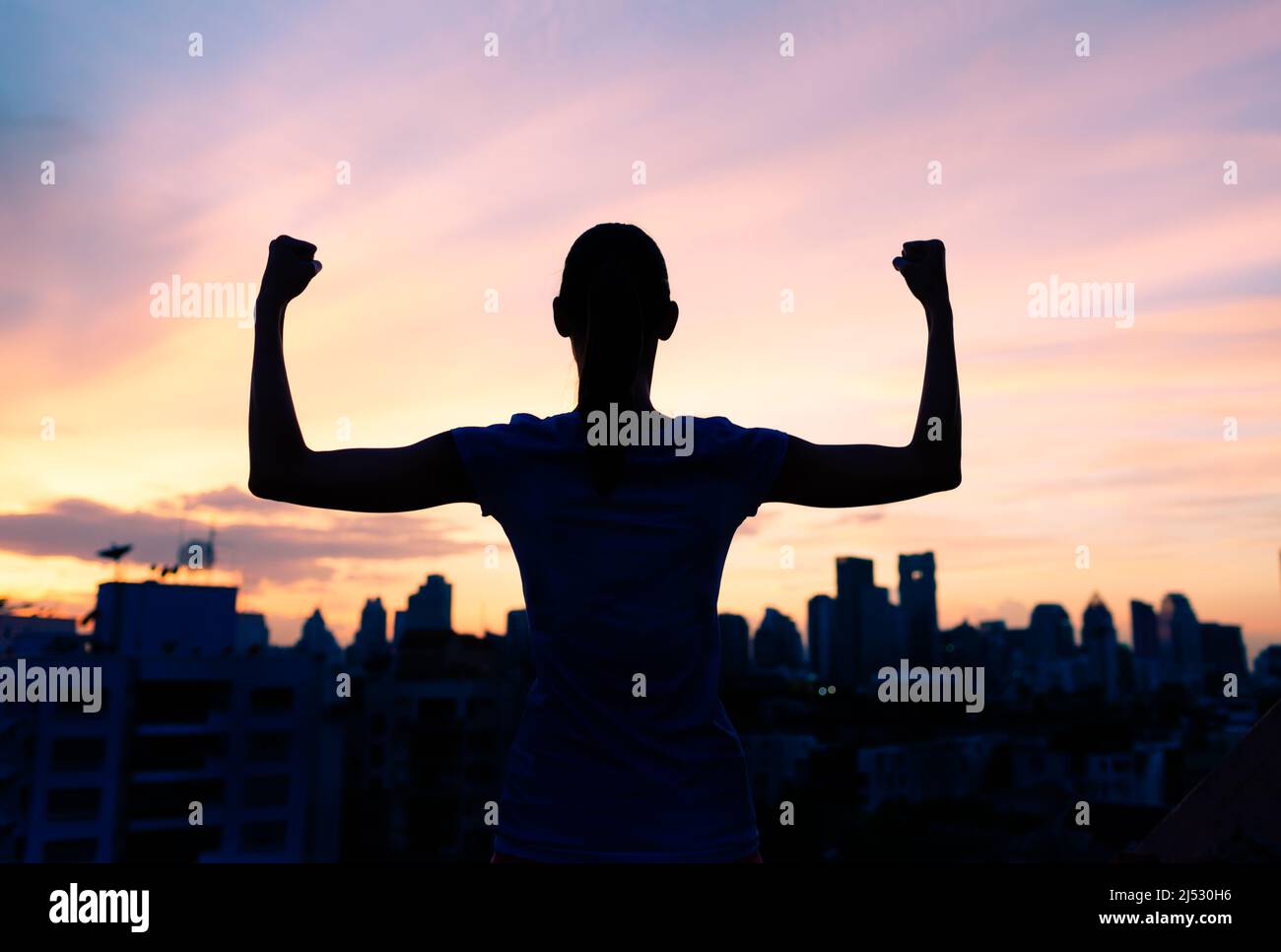 silhouette of strong young fearless woman standing in the city Stock ...