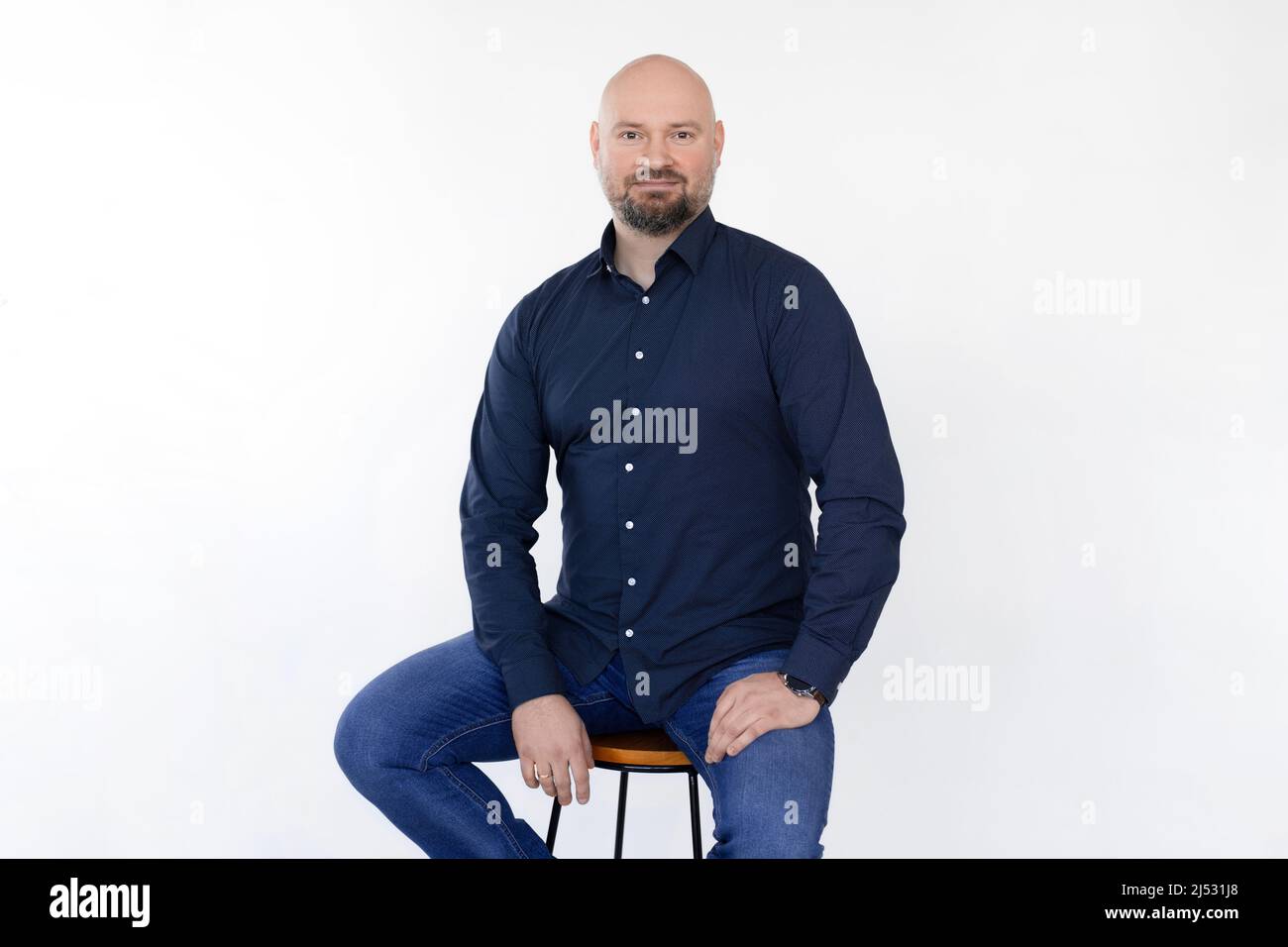 Portrait Of Happy Middle Aged Bald Bearded Man Wearing Blue Shirt And