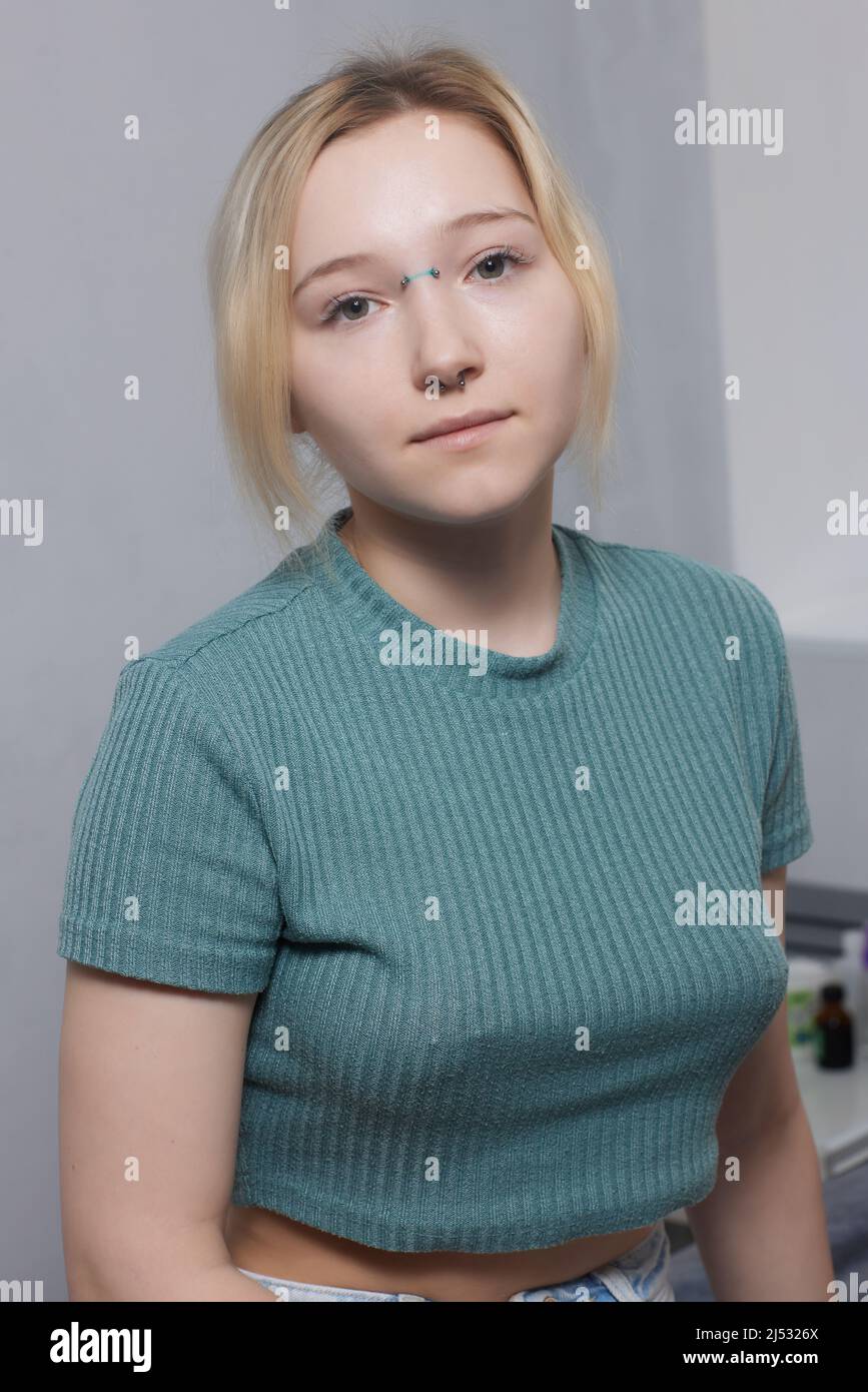 Nose Bridge Piercing Professional holding the jewel of piercing day ...