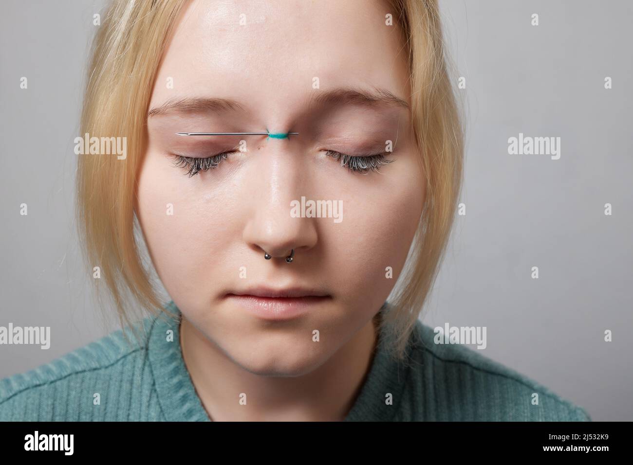 Nose Bridge Piercing Professional holding the jewel of piercing day ...