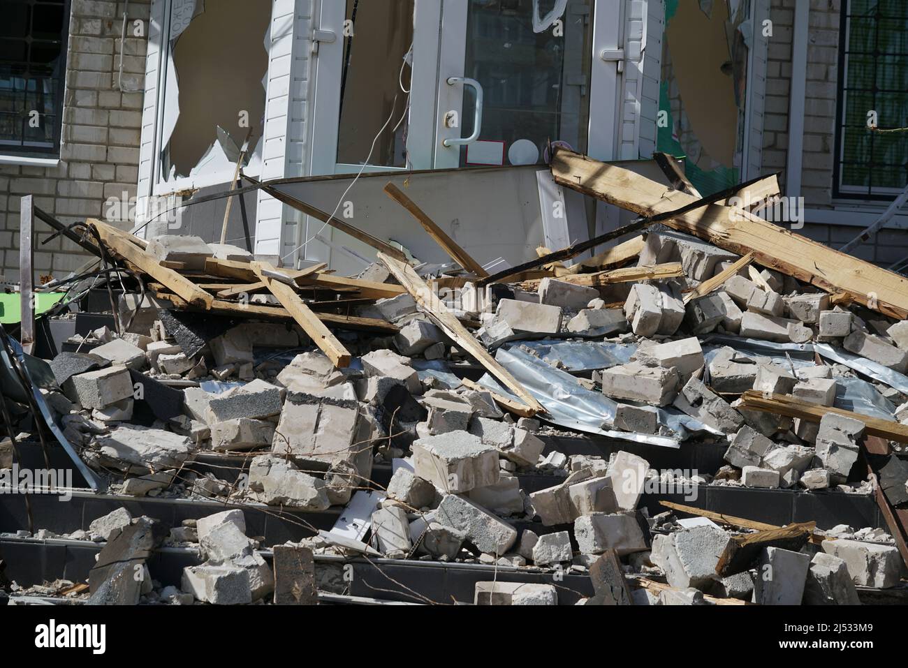 pieces and fragments of walls lie near the house after the explosion of ...