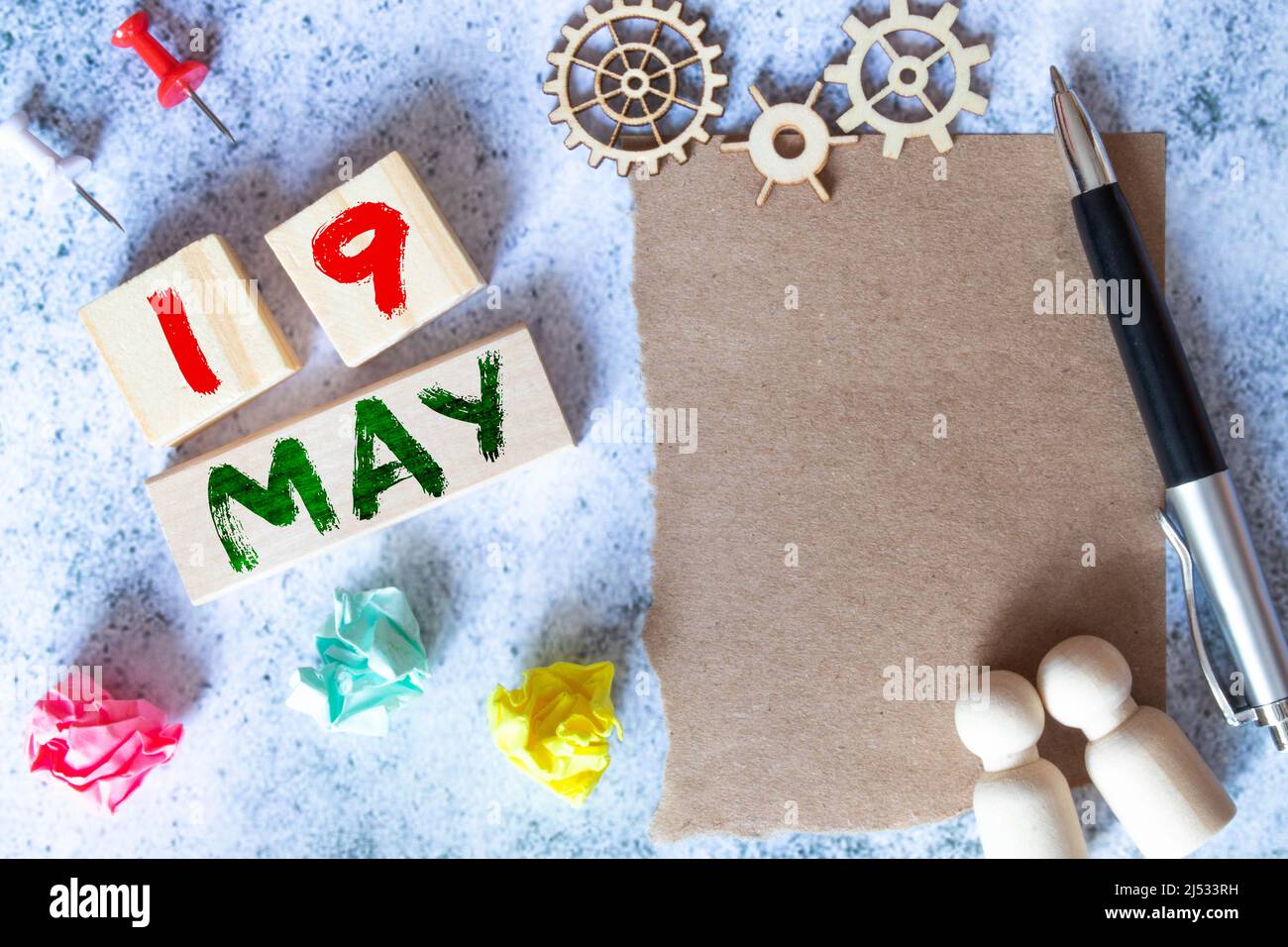 wooden calendar with date 19 May and easel on blue background, place ...