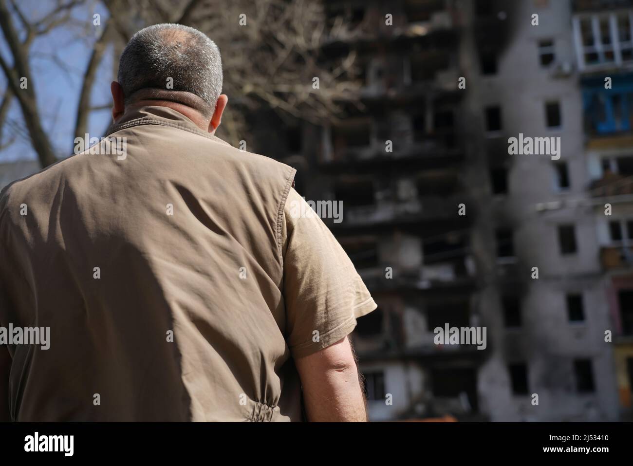 A man looks at a destroyed house that was hit by a shell Stock Photo ...