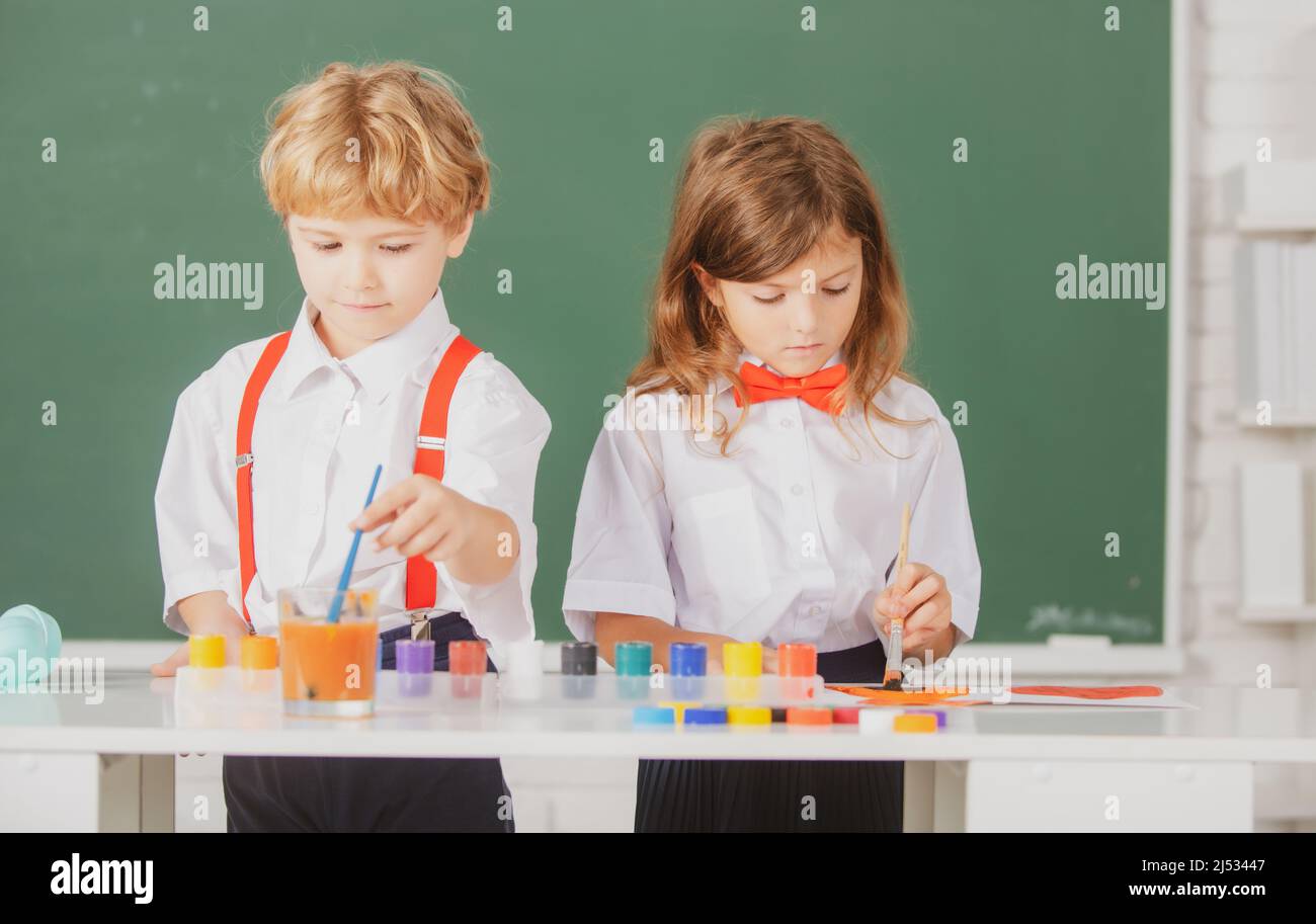 Cute school friends kids drawing and painting at school. Friendly boy ...