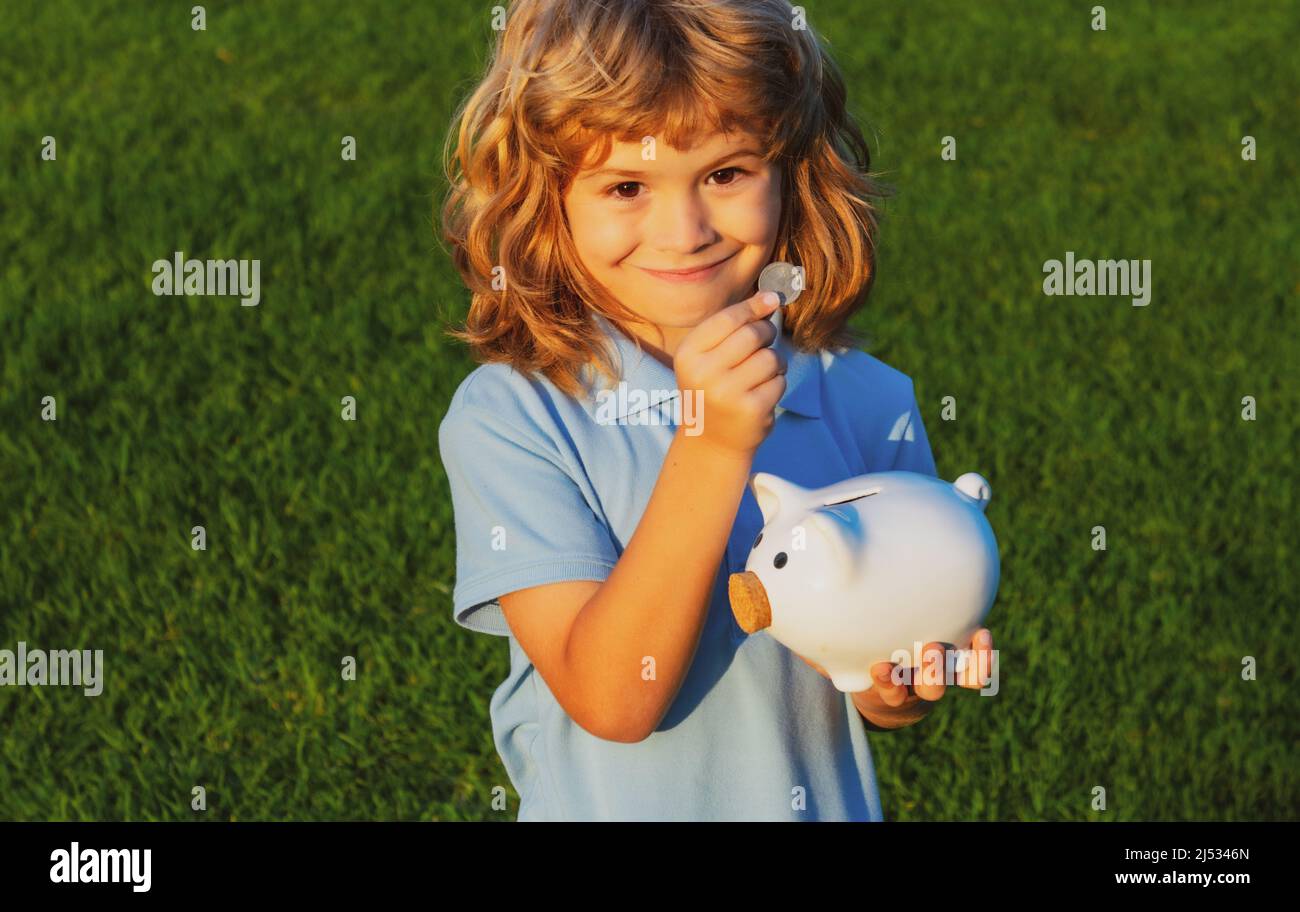 Piggy bank and little boy with coin. Baby child putting a coin into a ...