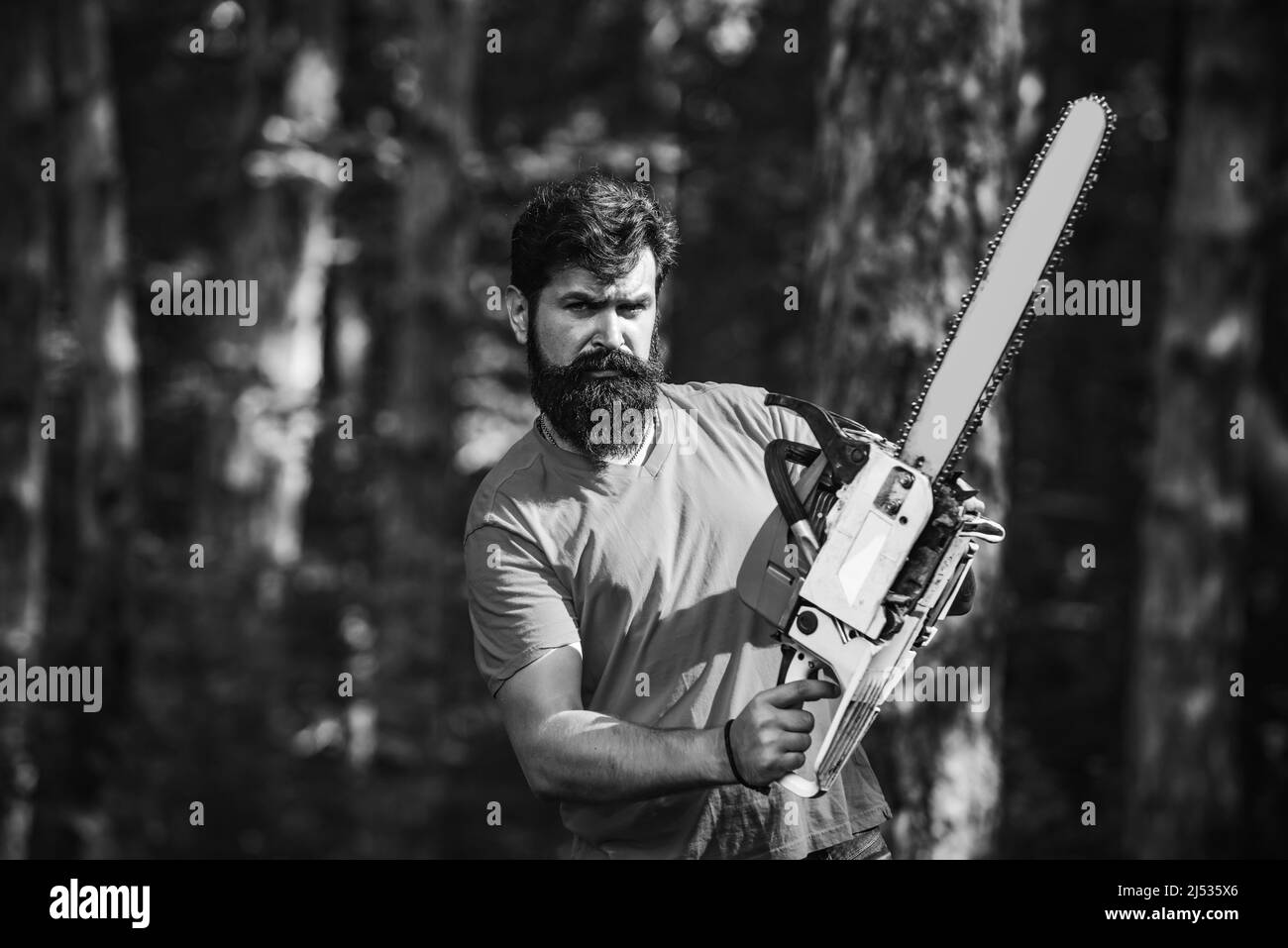 Handsome young man with axe near forest. Deforestation. Lumberjack in ...