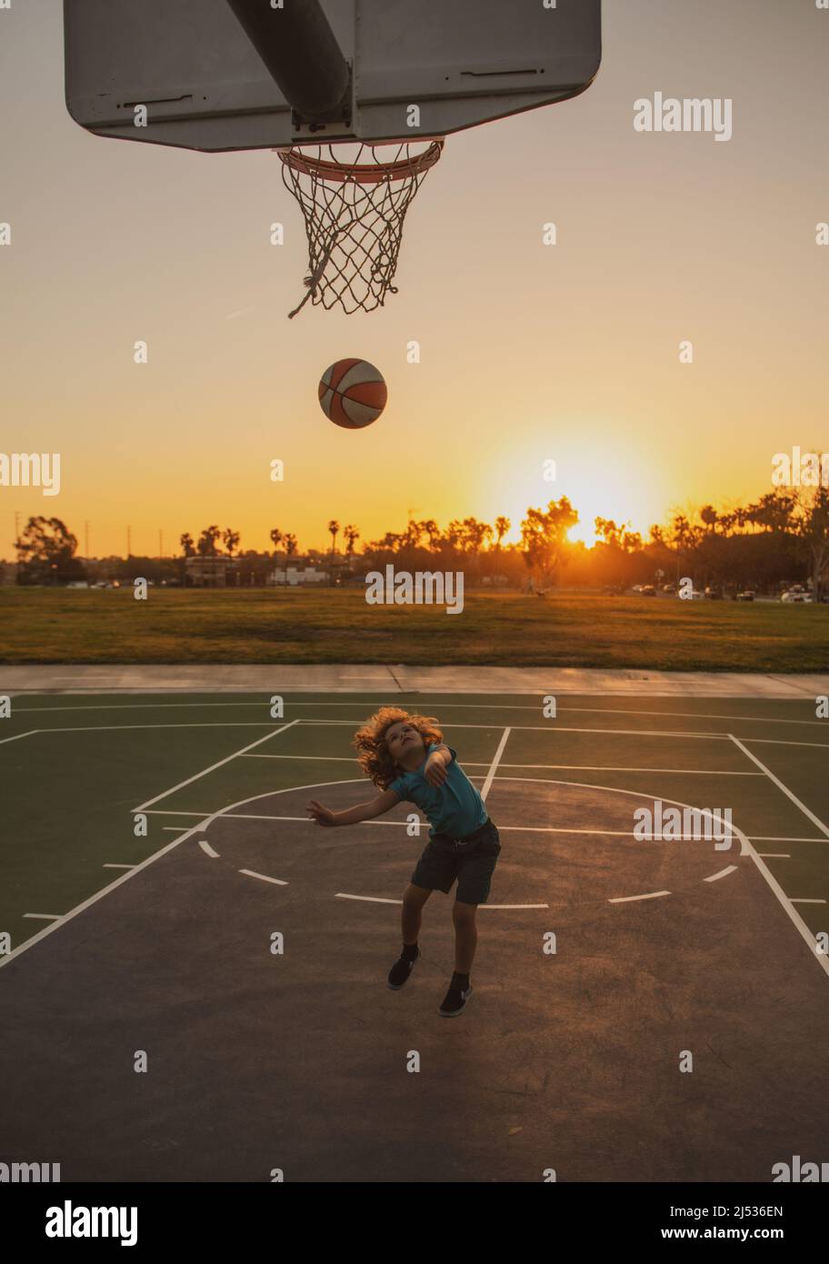 Happy little boy kid playing basketball on playground. Cute little boy ...