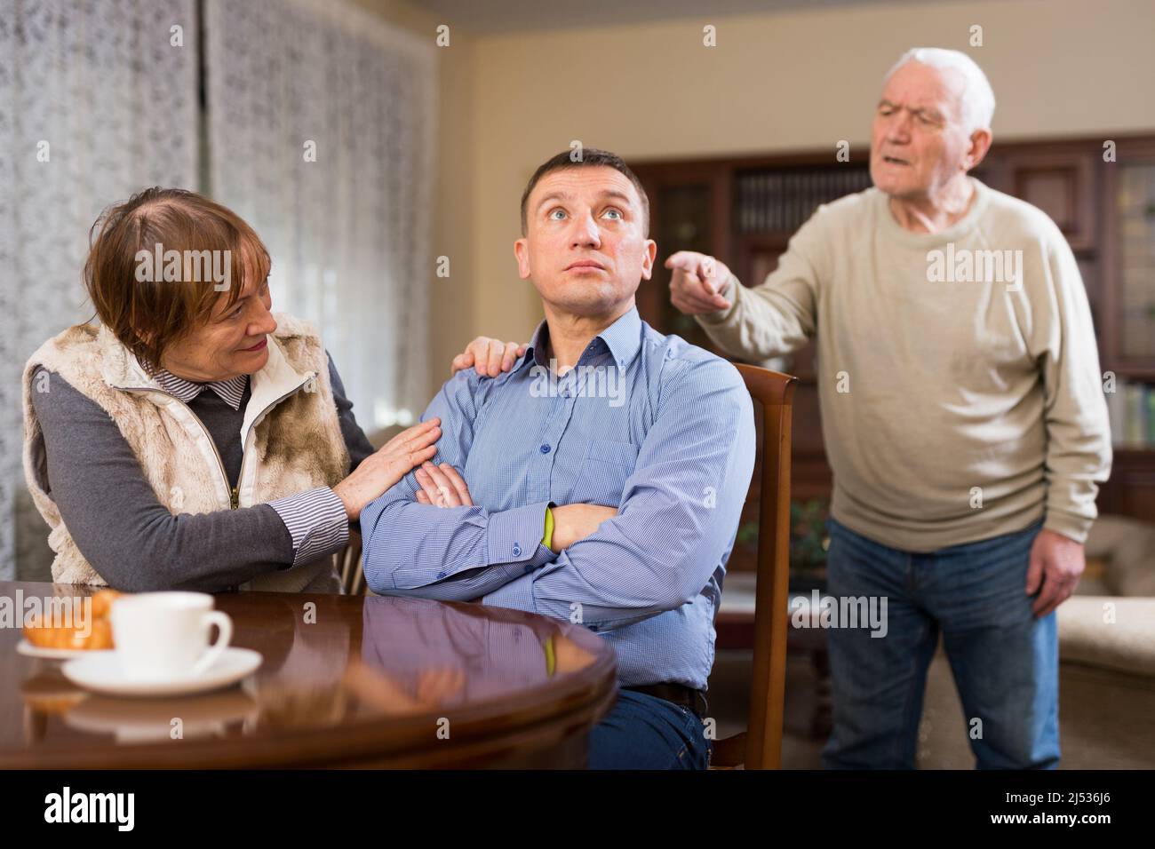 Senior man scolding his adult son Stock Photo - Alamy