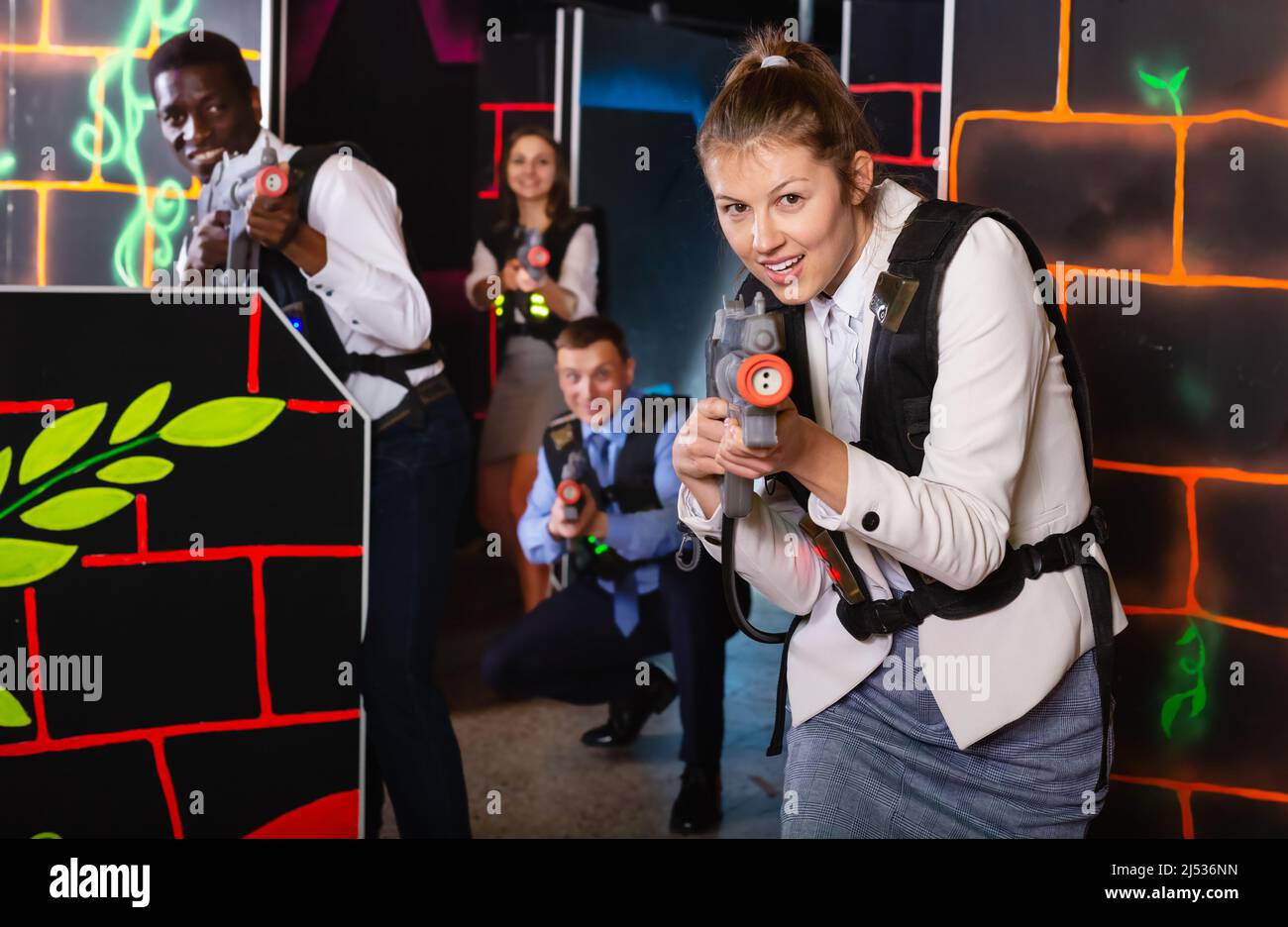 Woman holding laser gun and playing laser tag Stock Photo - Alamy
