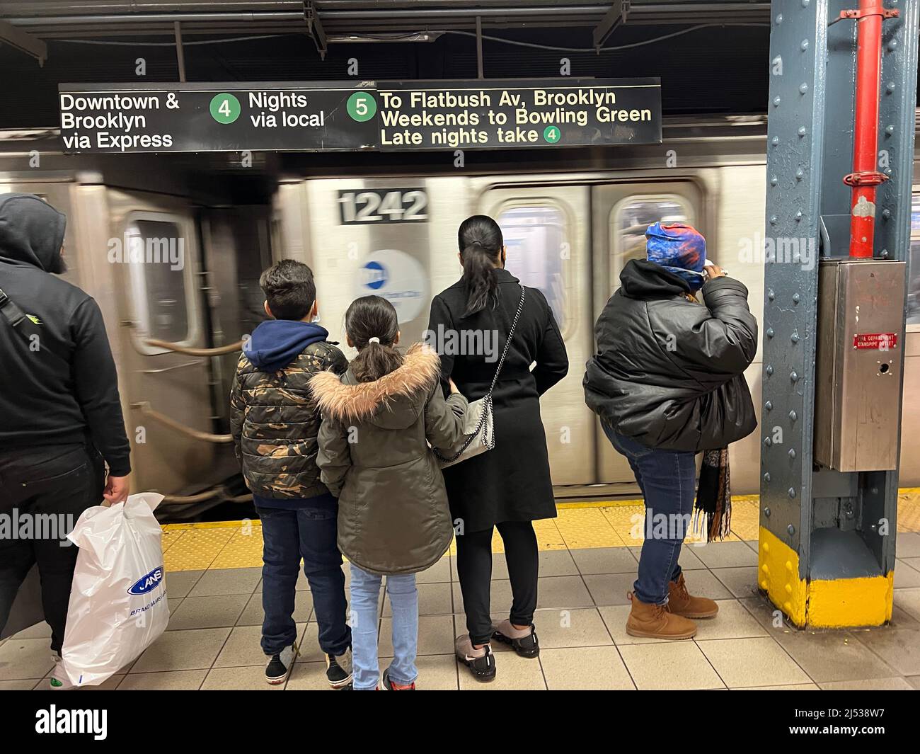 People wait for a train along the Lexington Line on the platform at the ...