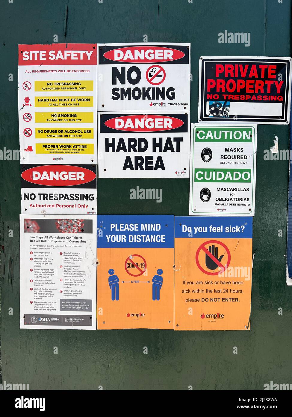 Warning and Danger signs posted on a construction wall behind which a ...