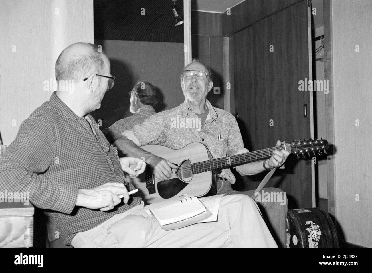 American folk singer Pete Seeger with journalist Karl Dallas backstage ...