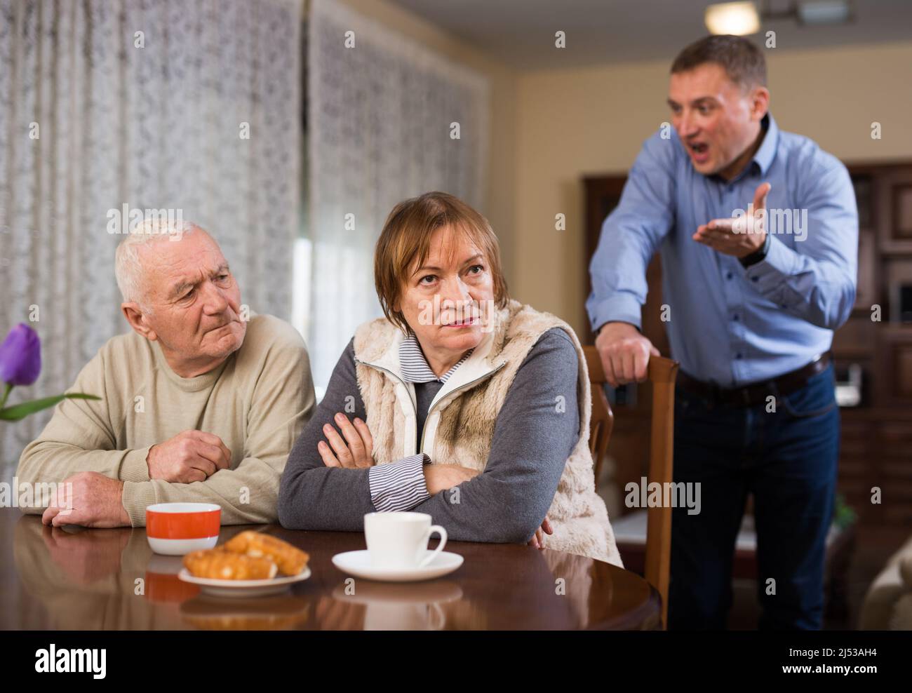 Man scolding his senior parents Stock Photo - Alamy