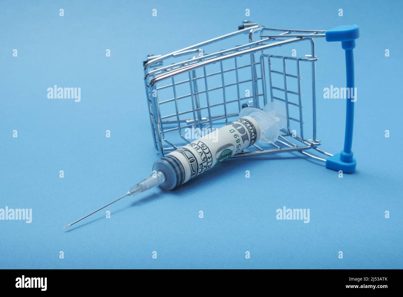 The syringe wrapped in a dollar is in the basket. Offering a financial ...