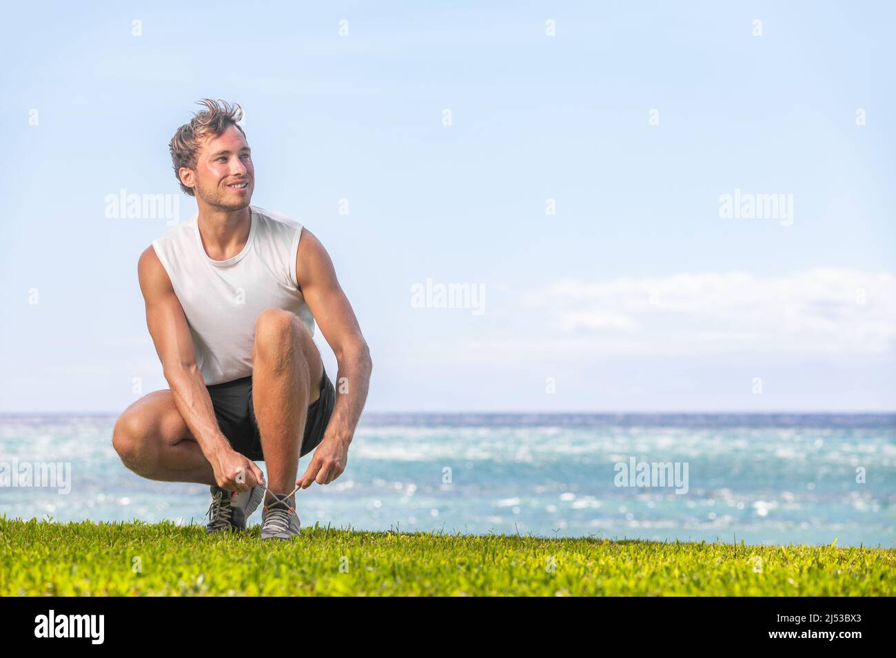 Happy healthy man getting ready to walk or jog on summer beach - Active ...