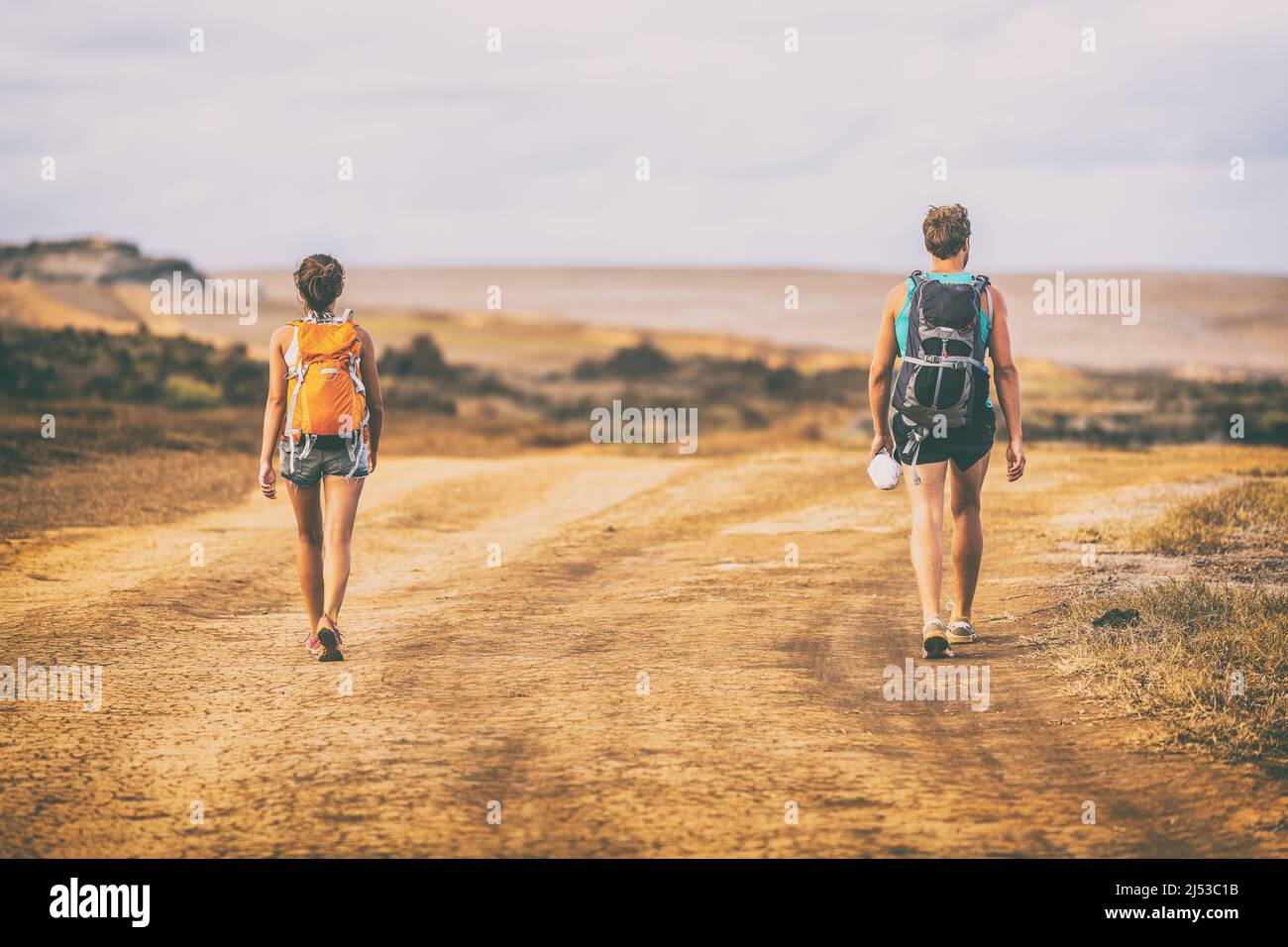 Hiking people walking on desert trail hike path with backpacks on ...