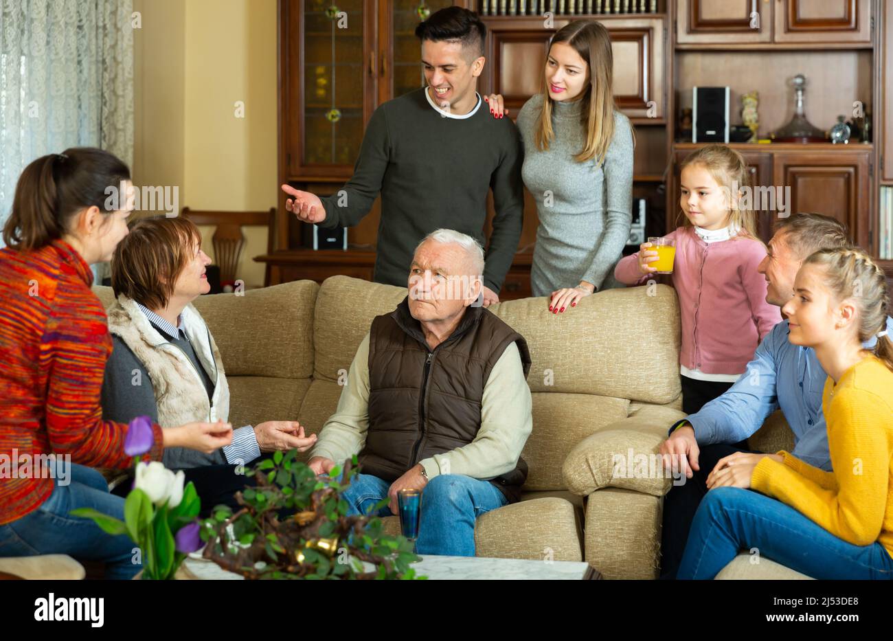 Happy family having conversation together Stock Photo - Alamy