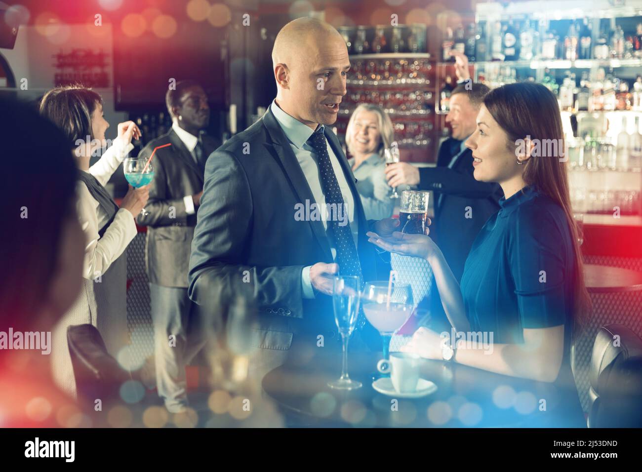 Man enjoying conversation with female colleague Stock Photo - Alamy