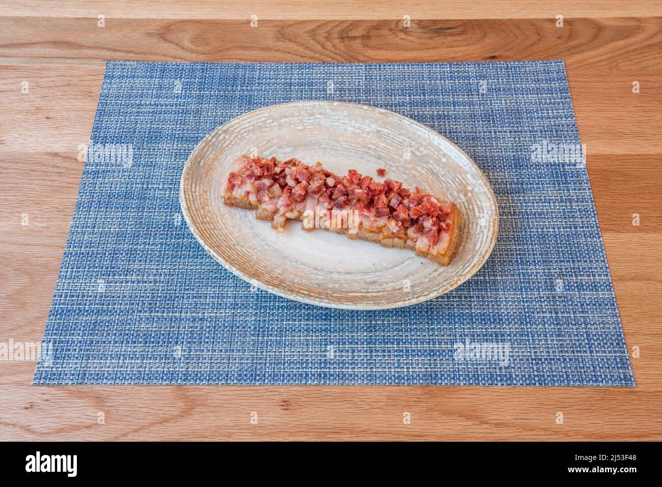 strip of bacon, always with its skin, fried or sautéed in a pan or ...