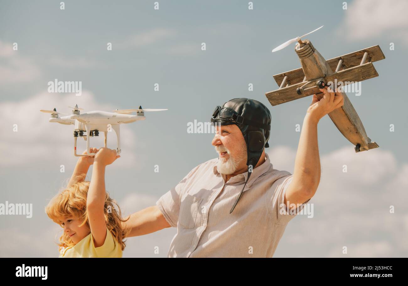 Old grandfather and young child grandson with plane and quadcopter ...