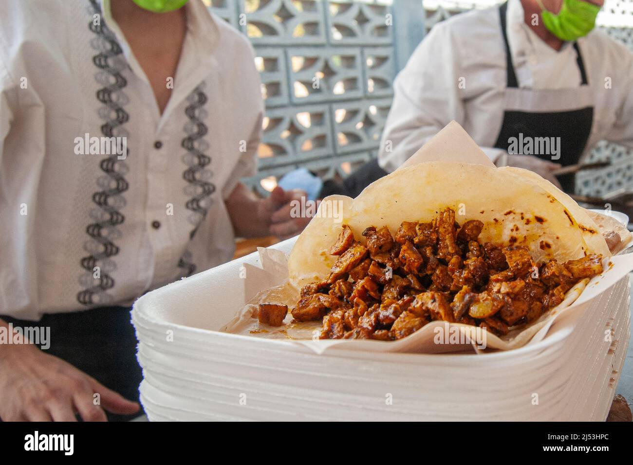 Taco man or TAQUERO preparing tacos on the street as part of the street ...