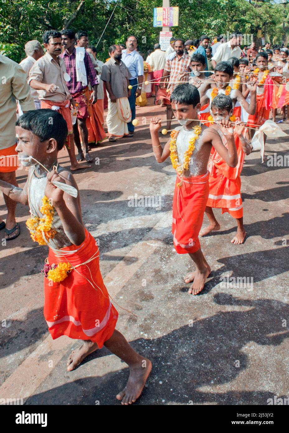 Young boys piercing spike through cheeks discharging vow in Thaipusam ...