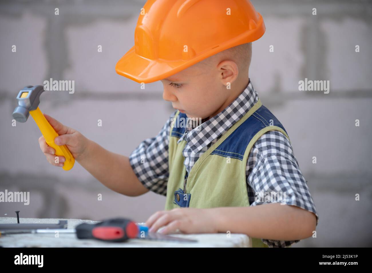 Portrait of little builder in hardhats with instruments for renovation ...