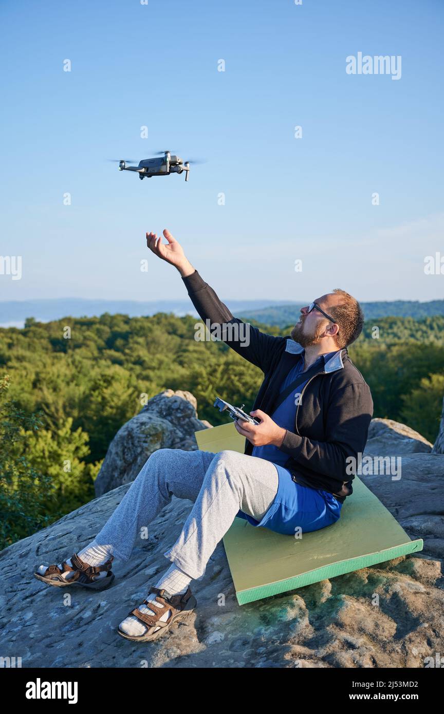 Operating drone in mountains hi-res stock photography and images - Alamy