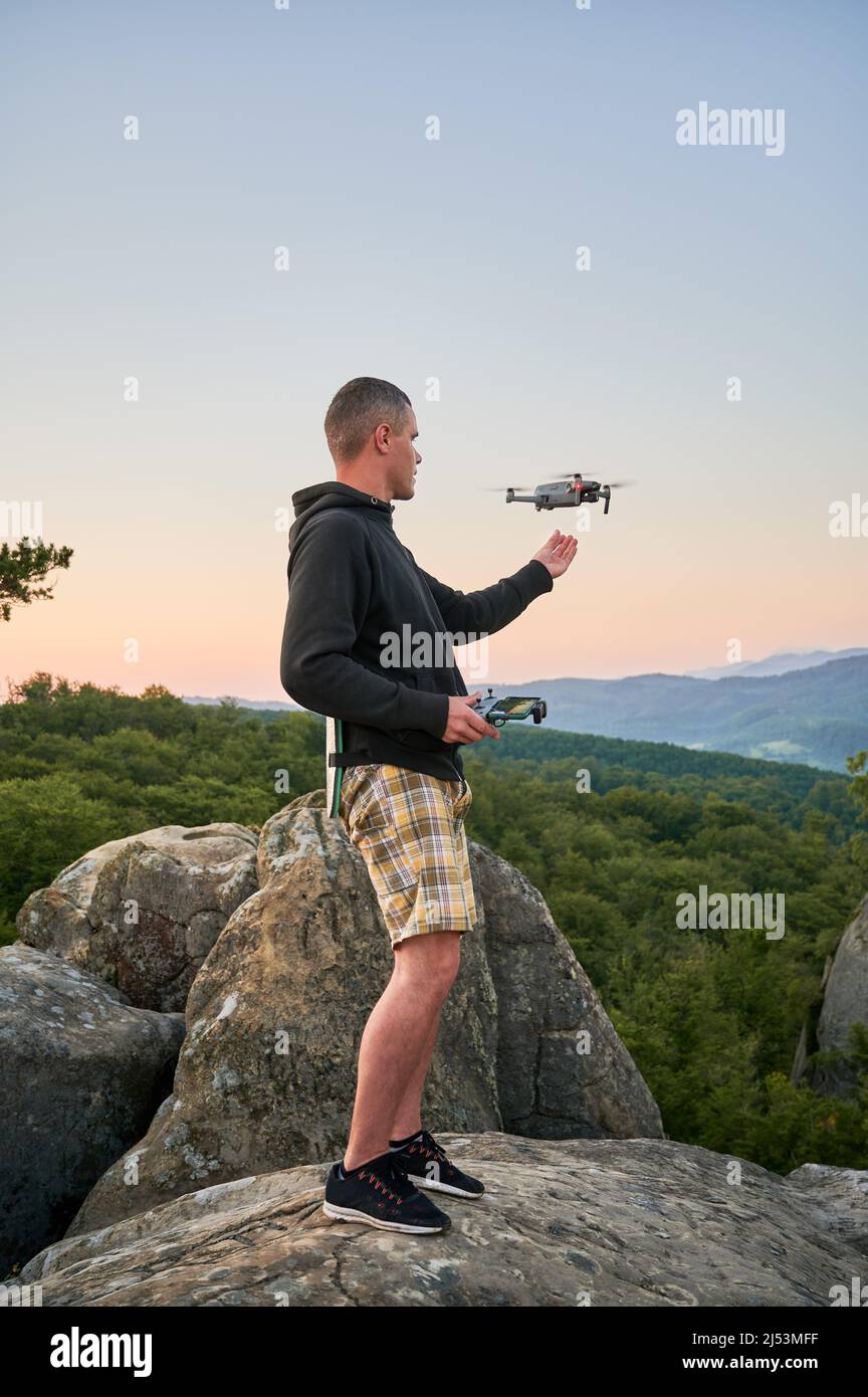 Operating drone in mountains hi-res stock photography and images - Alamy