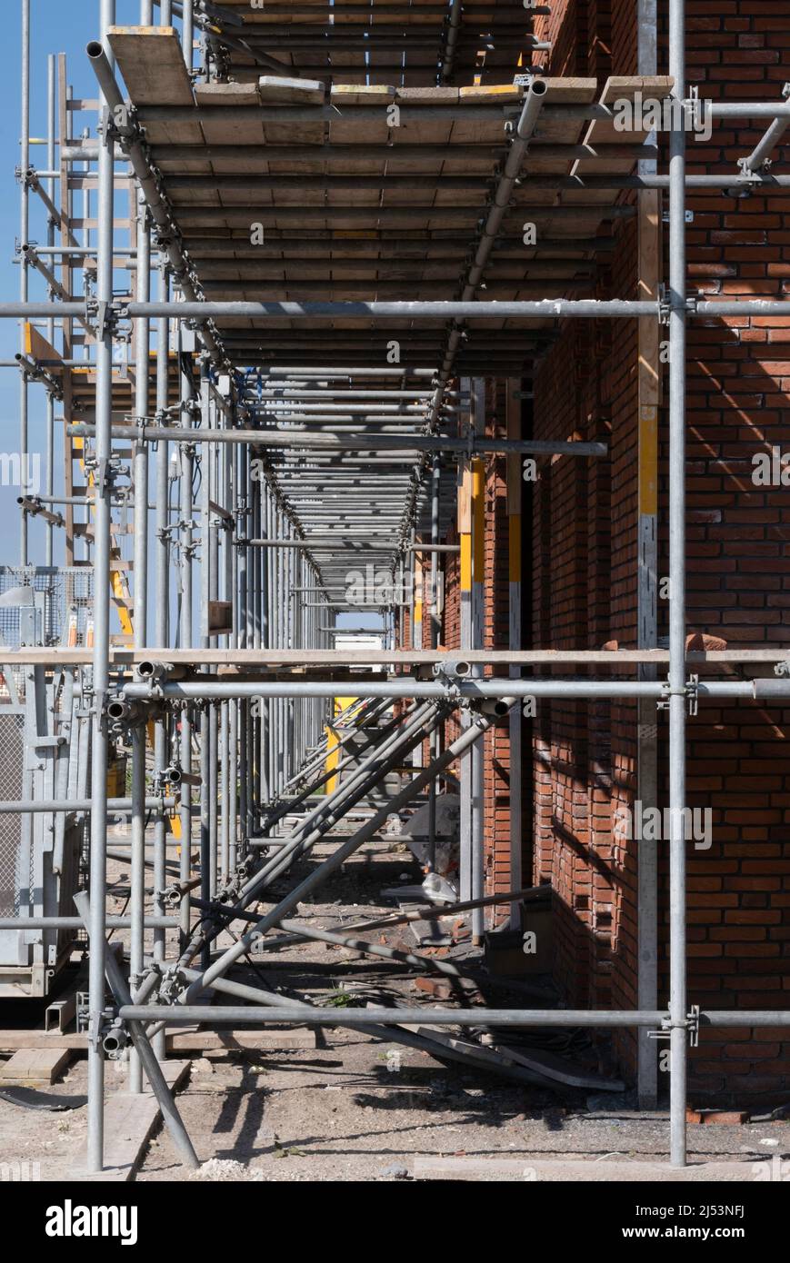 Scaffolding on a construction site of a row of new houses to be built ...