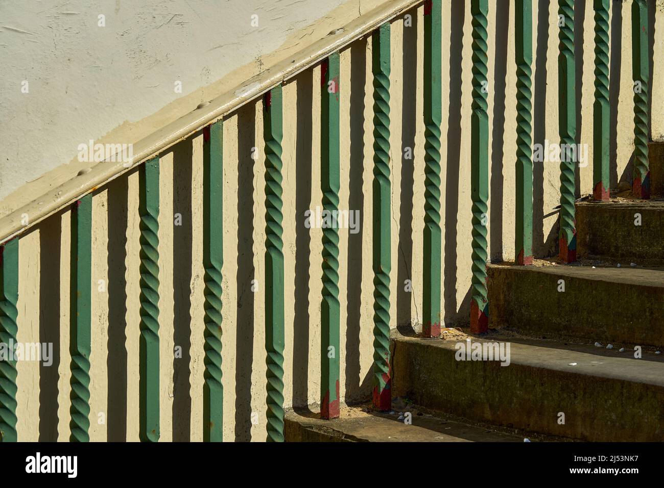 An abstract photo of green railings and concrete steps Stock Photo - Alamy