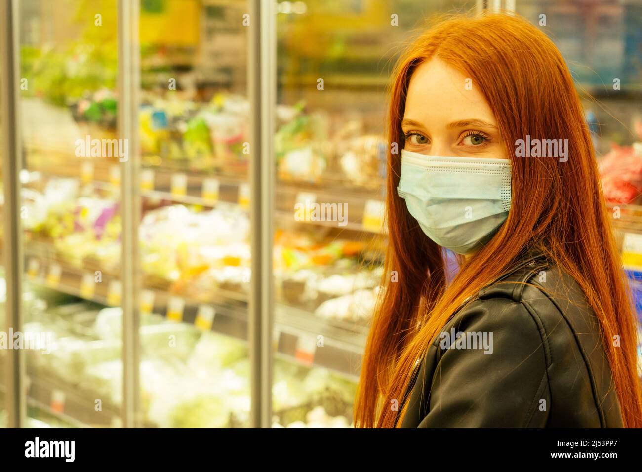 redhaired ginger woman in casual black leather jacket buying products ...