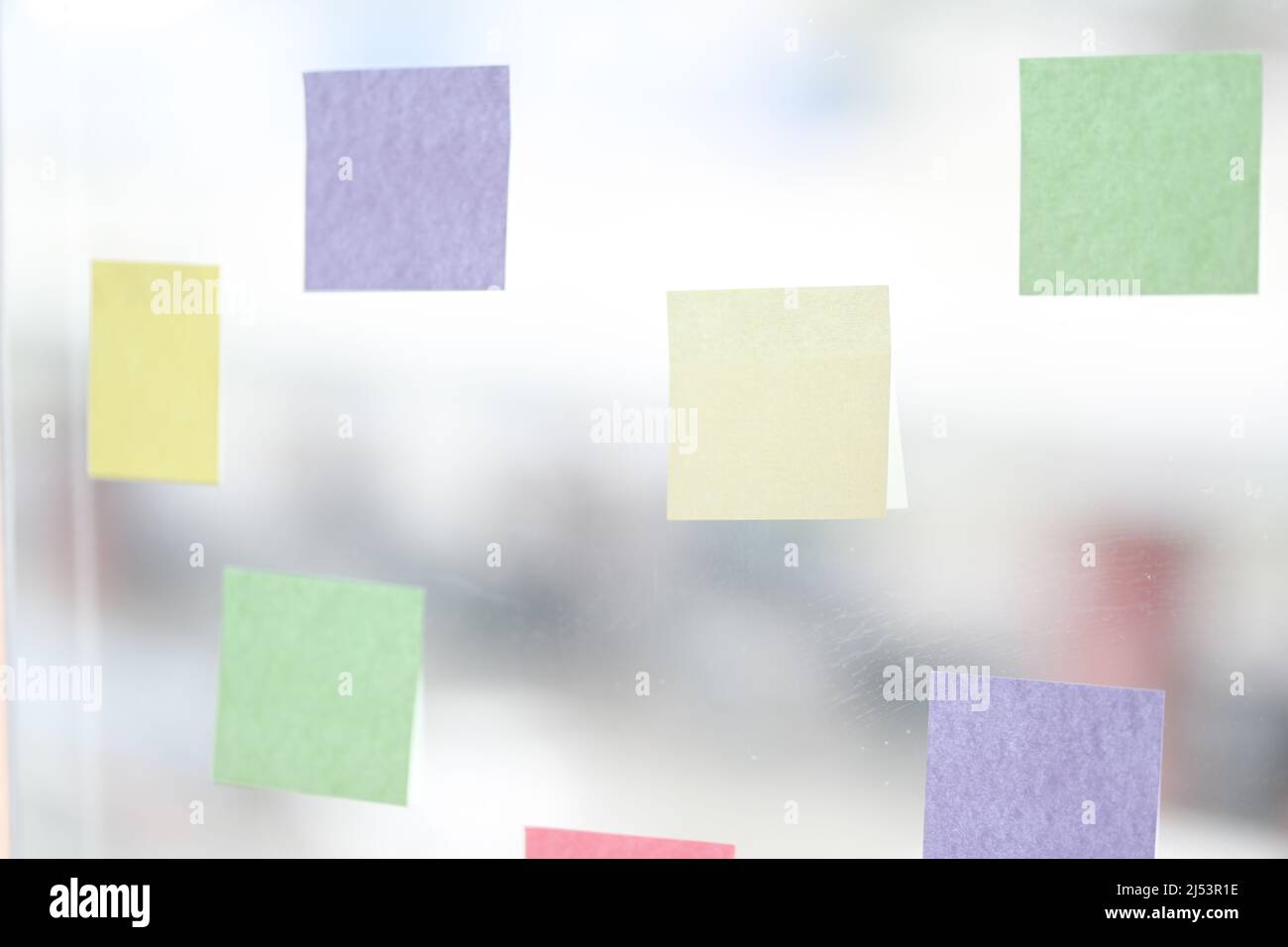 Empty colourful sticky notes on glass wall. close-up image, Sharing ...