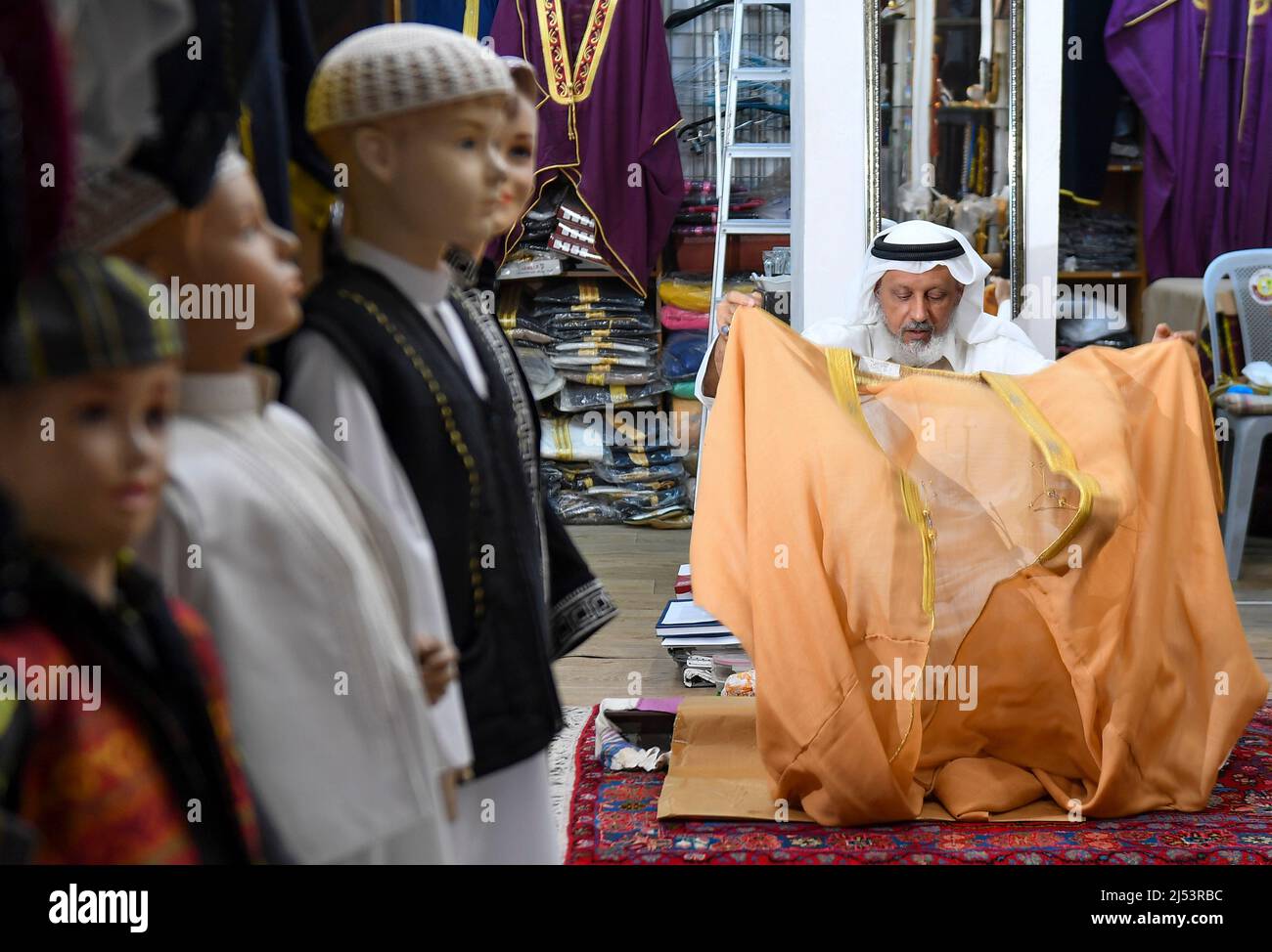 Doha, Qatar. 19th Apr, 2022. A tailor makes traditional dresses at a ...