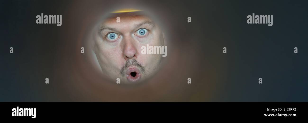 Man on his face uses facial expressions surprise Stock Photo - Alamy