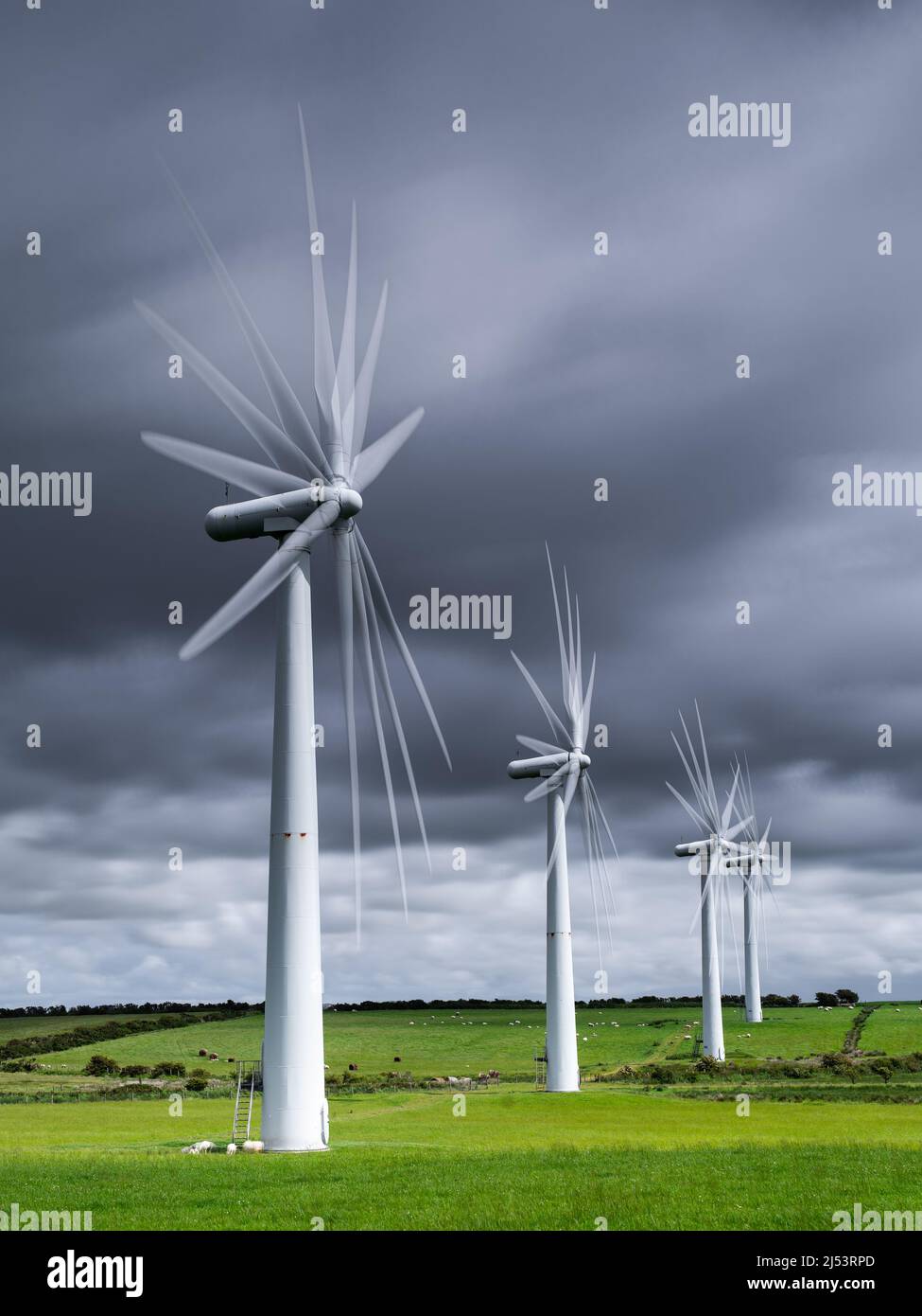 Wind turbine multiple exposure showing blade movement against a stormy ...