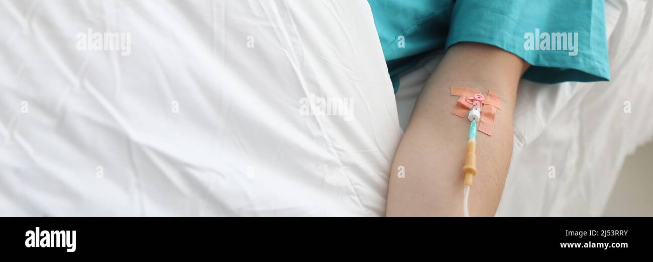 Man lies in hospital with syringe in vein his arm Stock Photo - Alamy