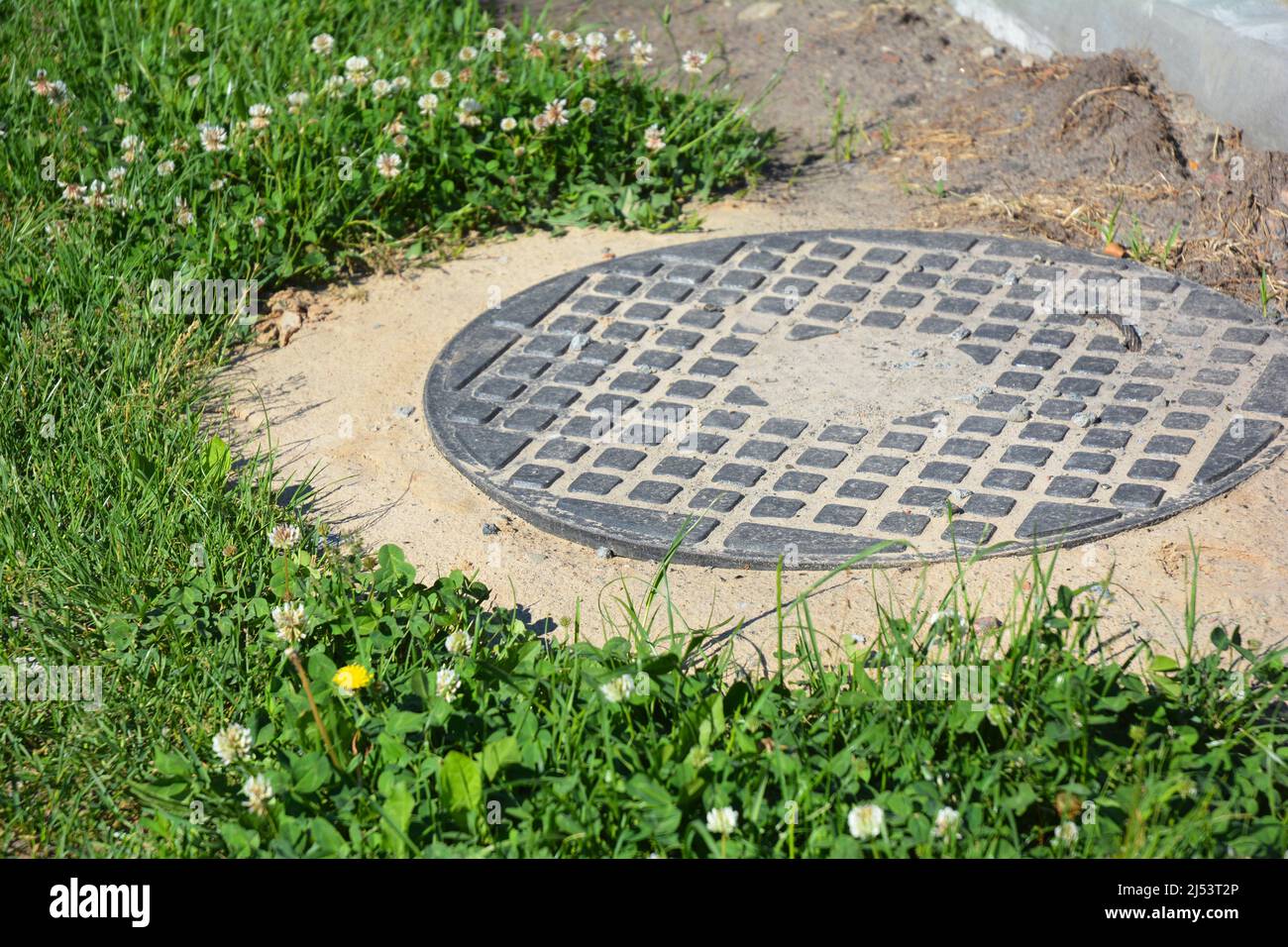 Manhole cover installation in the garden Stock Photo - Alamy