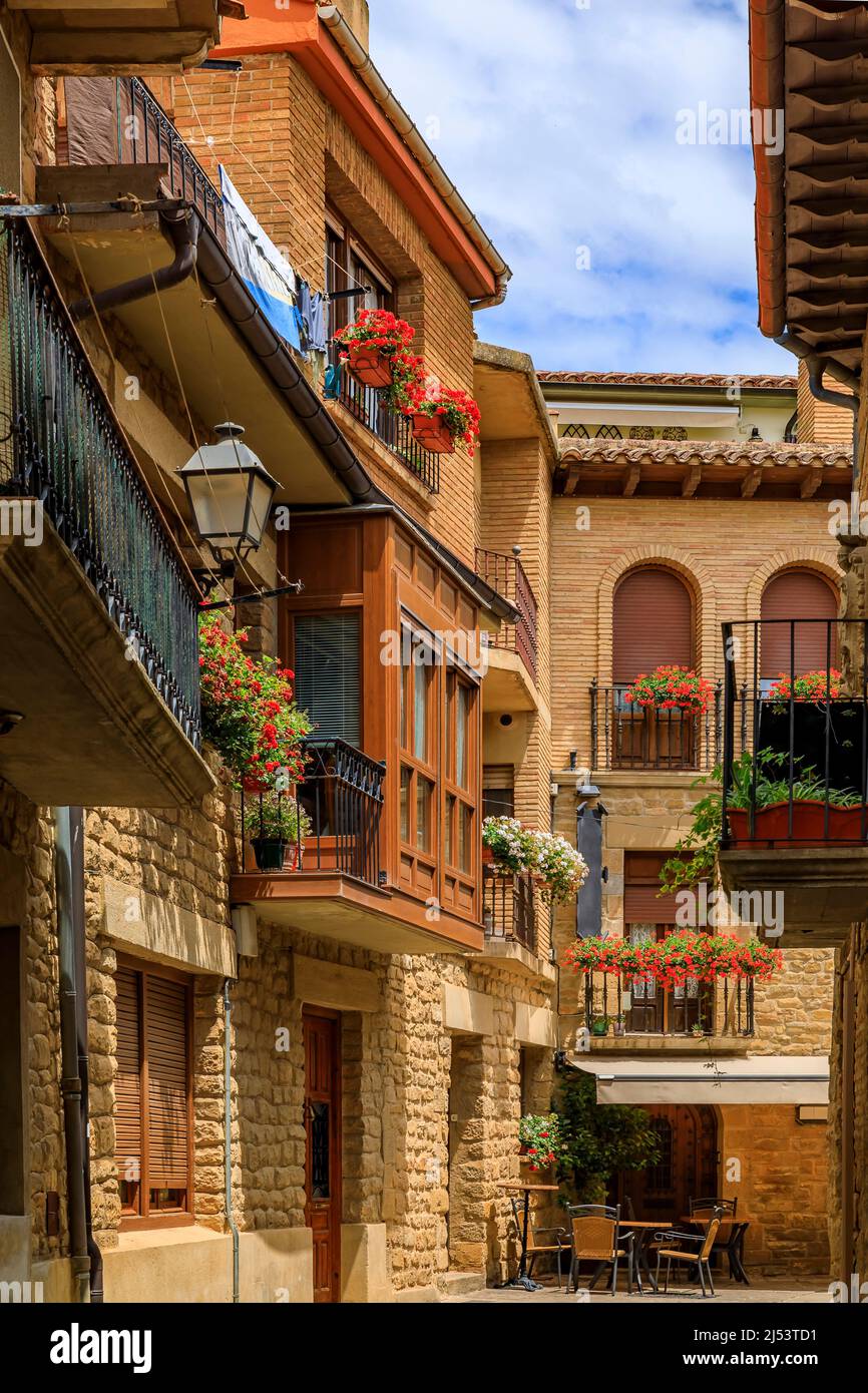 Rustic medieval stone house facades and ornate metal balconies with ...