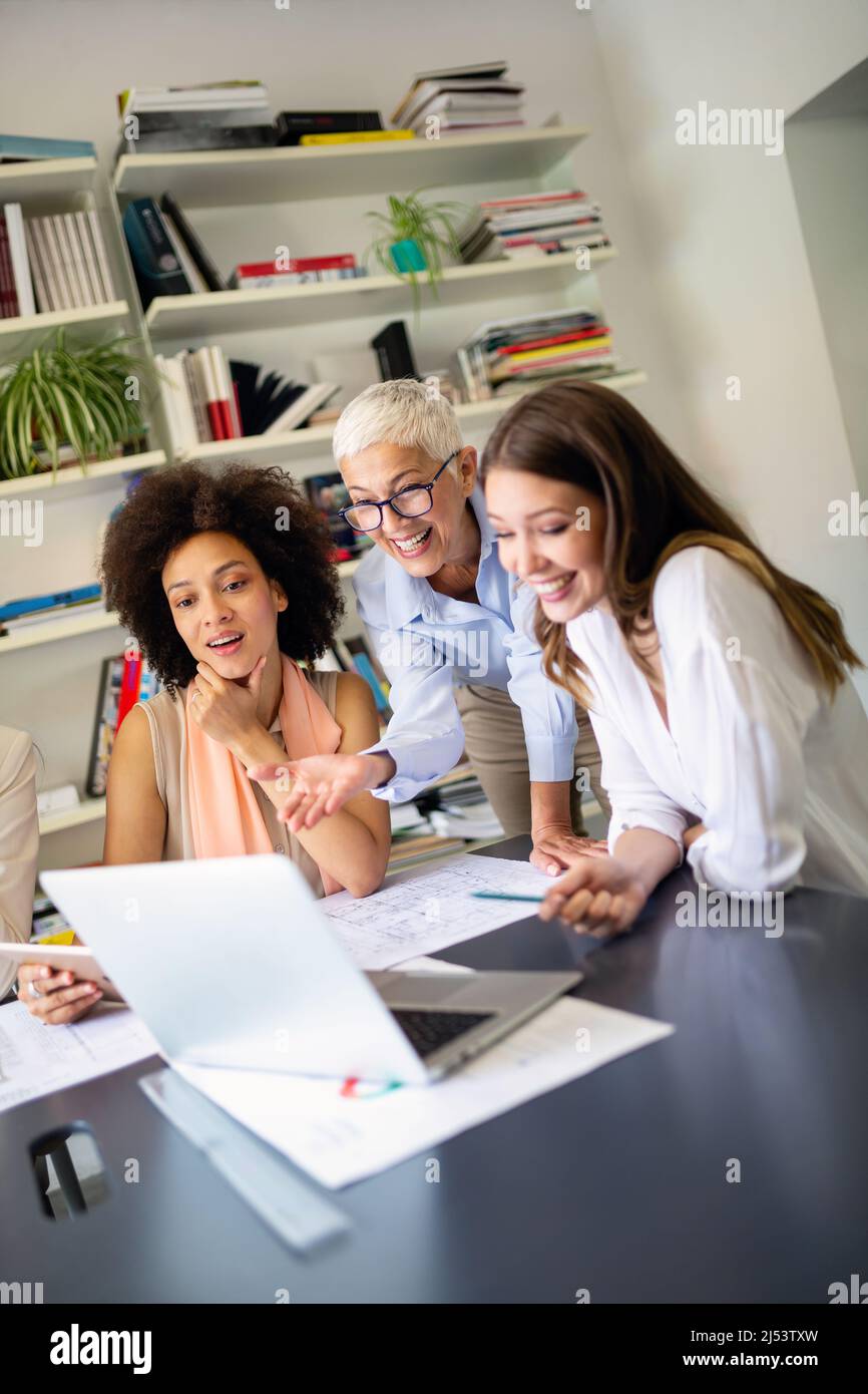 Group of happy successful women colleagues working together on meeting ...
