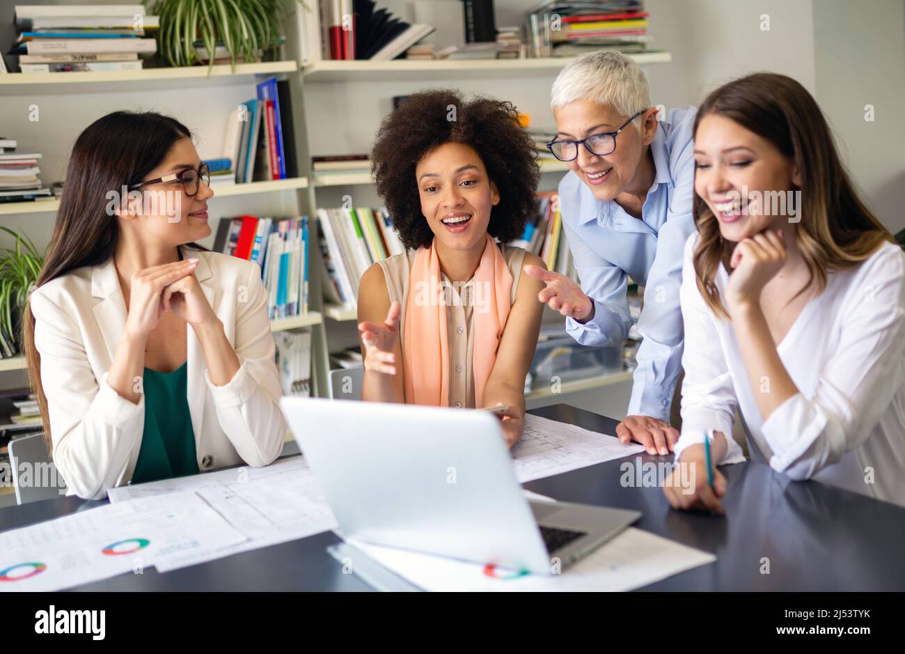 Group of happy successful women colleagues working together on meeting ...